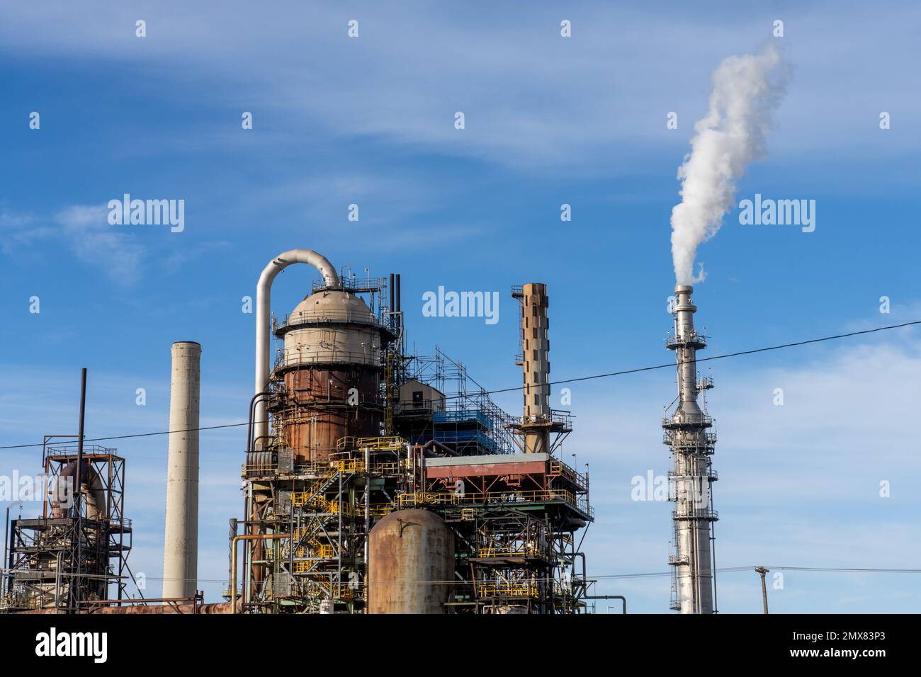 An FCCU or Fluid Catalytic Cracking Unit and a tower emitting steam in ...