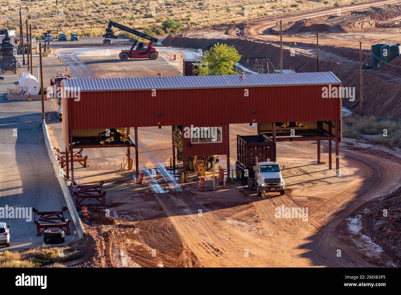 An empty container truck pulls through after having its container cap ...