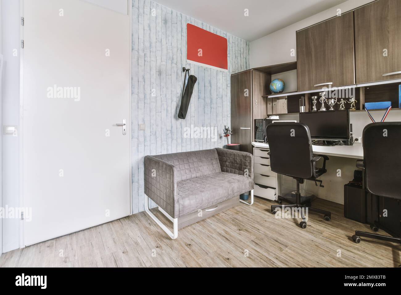 Interior design of home office with sofa and shelves placed near table ...