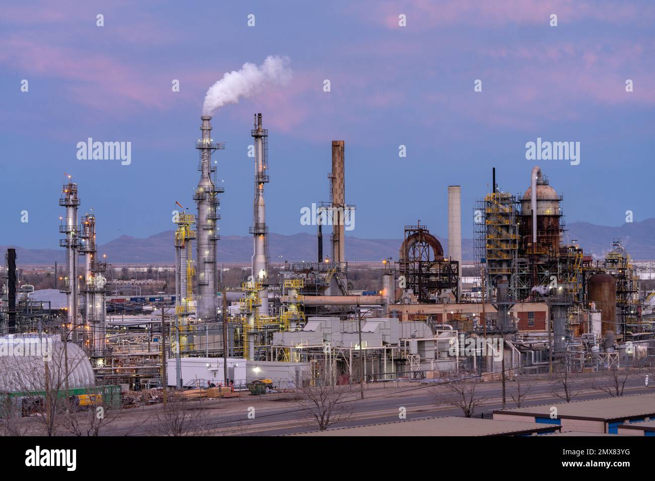 An oil refinery lit up in pre-dawn twilight near Salt Lake City, Utah ...
