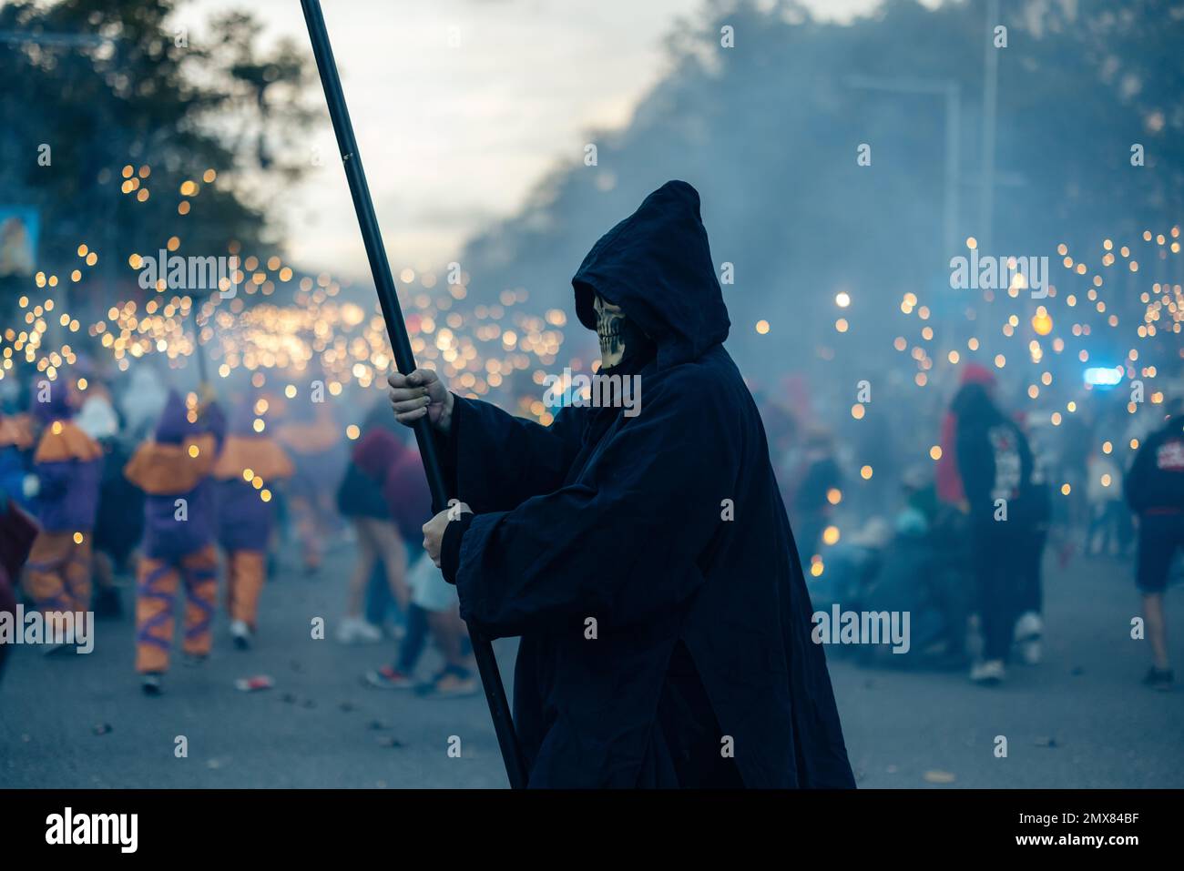 Side view of anonymous person in death costume with hood standing ...