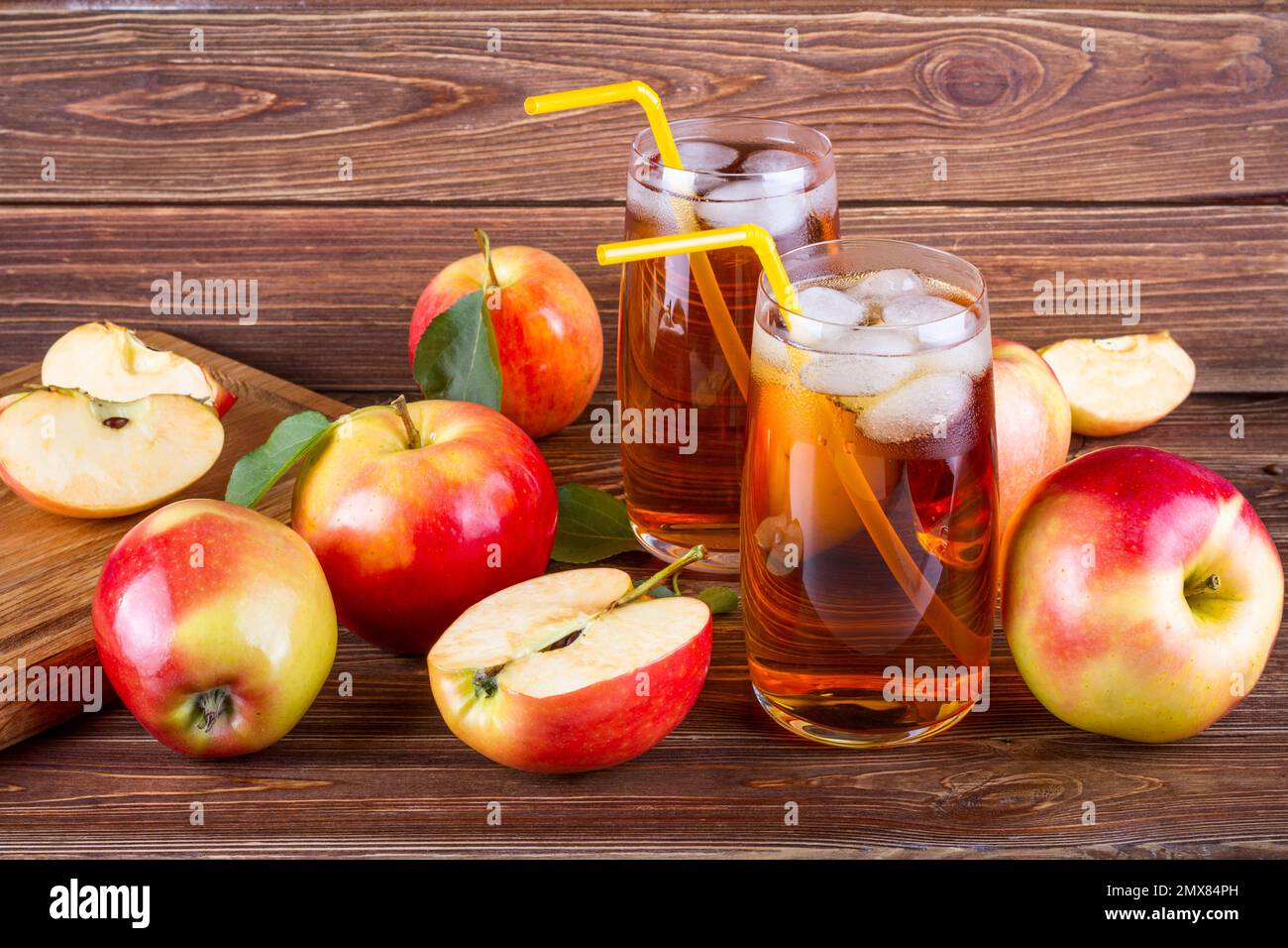 Fresh organic farm apple juice with ice in glass with raw whole and ...