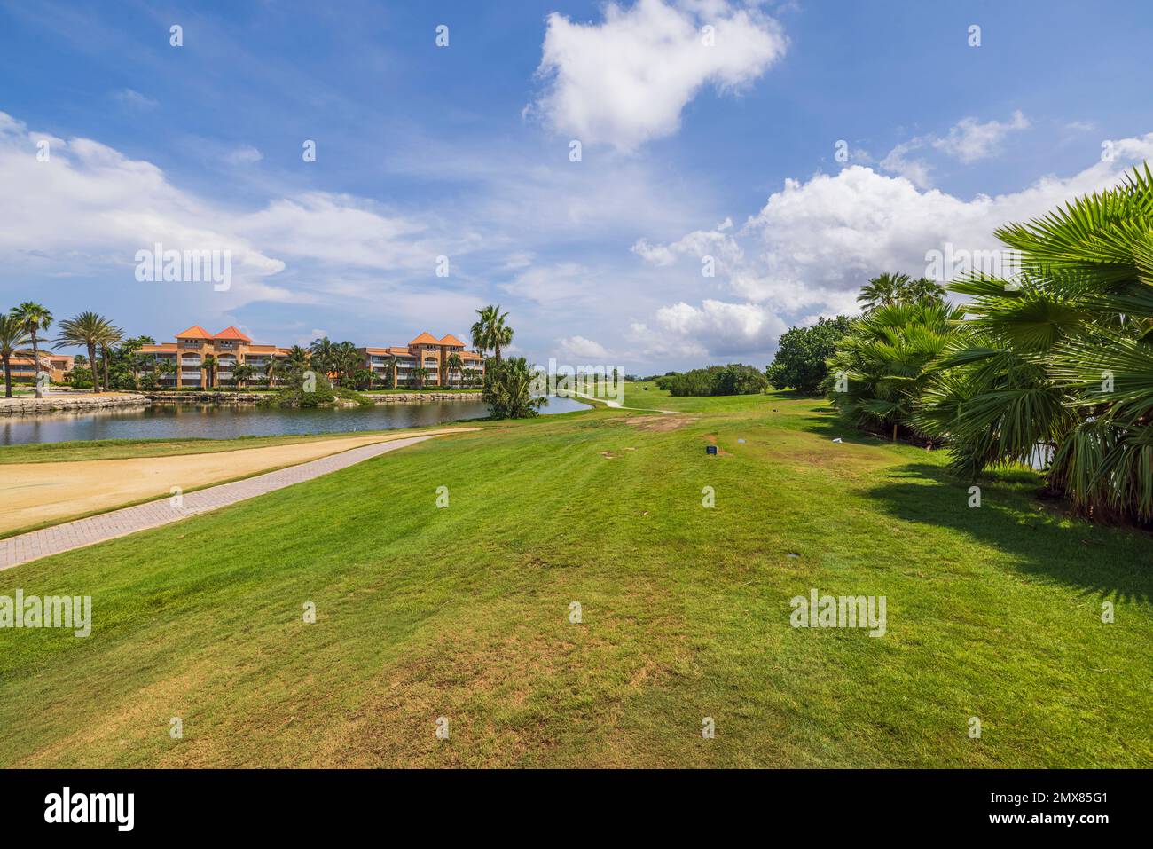 Gorgeous view of hotel building and blue water surface of pond and ...