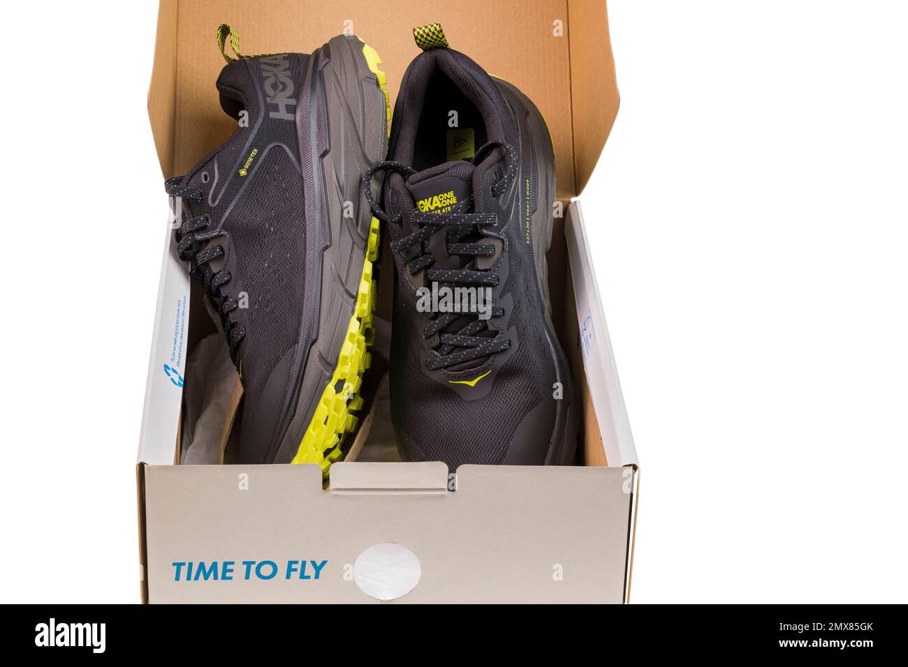 Close-up view of Hoka sneakers in carton box isolated on white ...