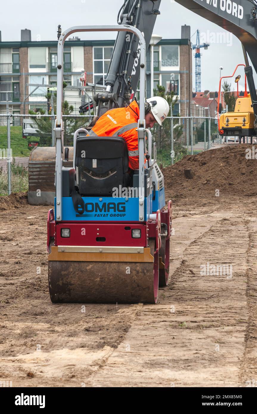 roller operator of a road roller at work on a construction site Stock ...