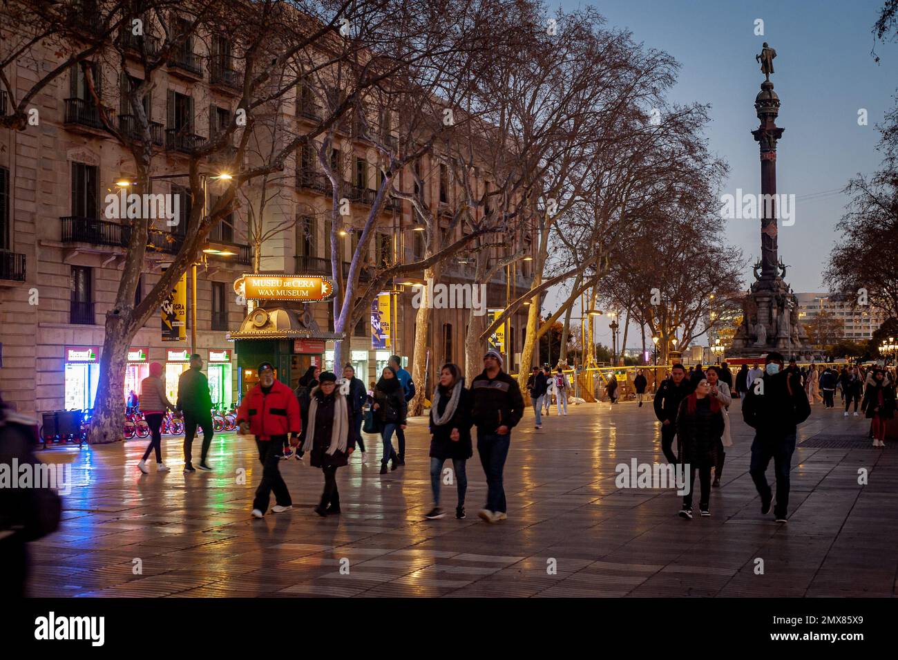 People walk down La Rambla avenue in Barcelona with Christopher ...