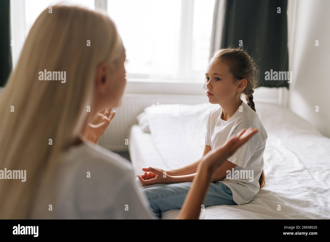 Close up back view of unrecognizable aggressive young mother scolding, raising voice, scream and ...