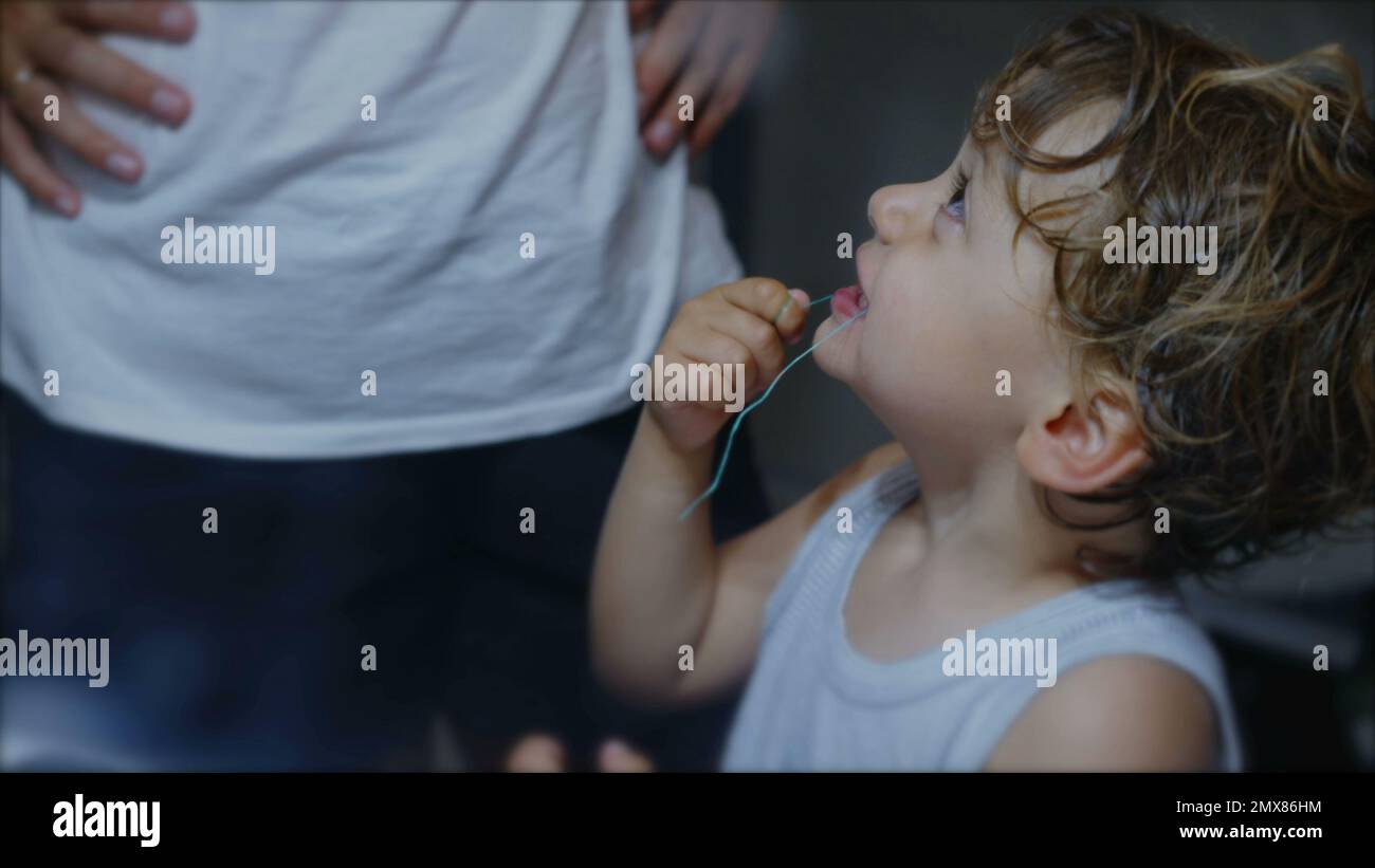 Child flossing teeths. Parent helping little boy to floss mouth. Child ...