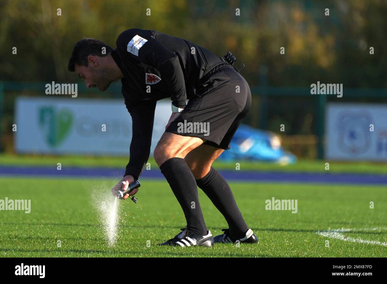 FA Wales referee marking a free kick line with water vanishing spray Stock Photo - Alamy