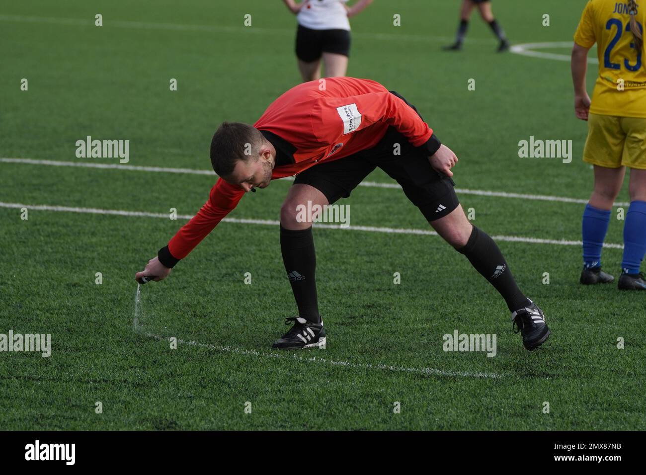 FA Wales referee marking a free kick line with water spray Stock Photo ...