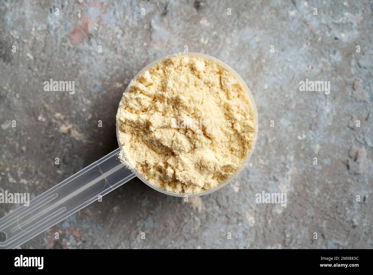 Whey protein powder in a plastic measuring scoop, top view Stock Photo ...