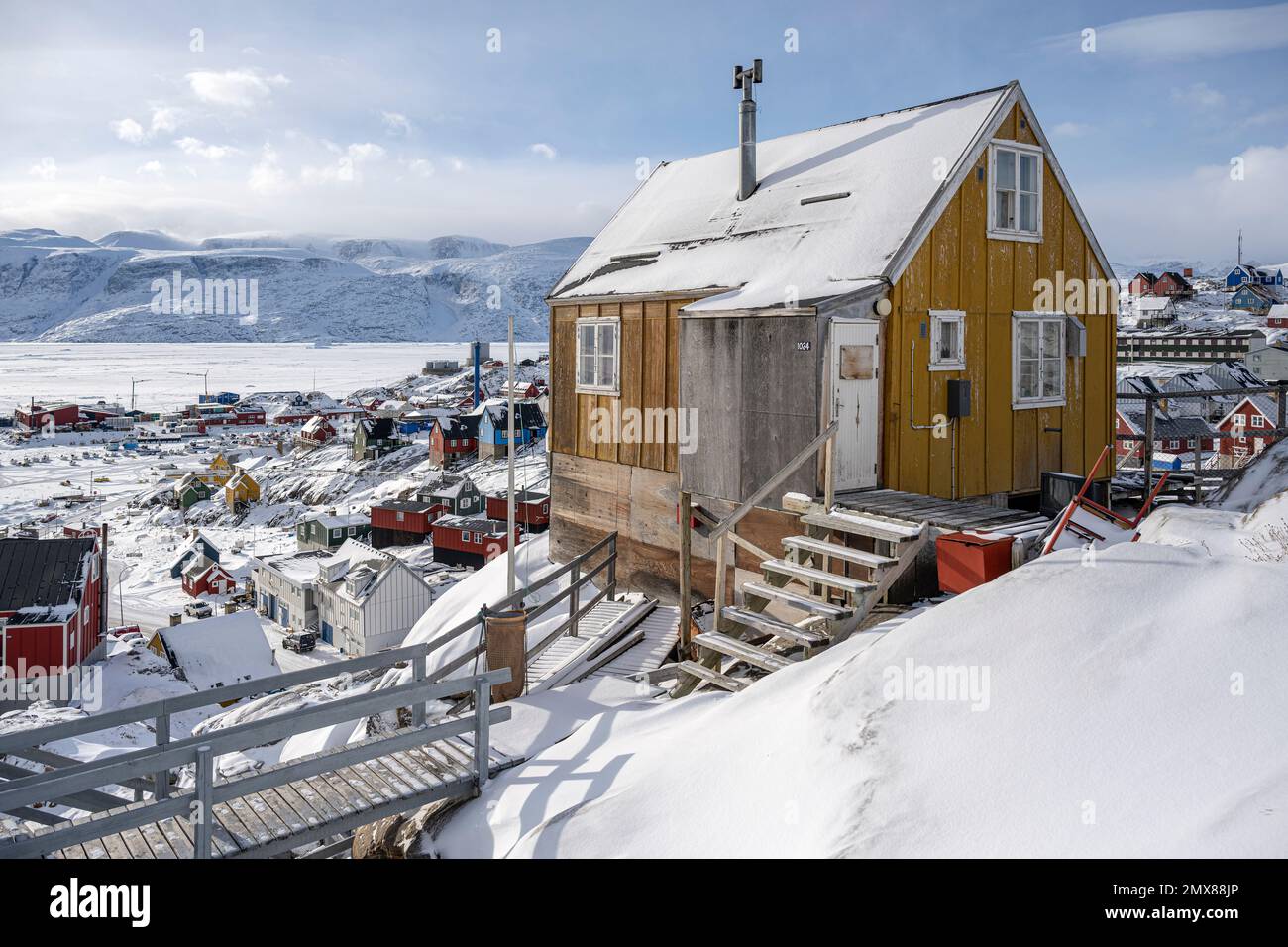 Colourful houses clinging to the side of the mountain at Uummannaq in ...