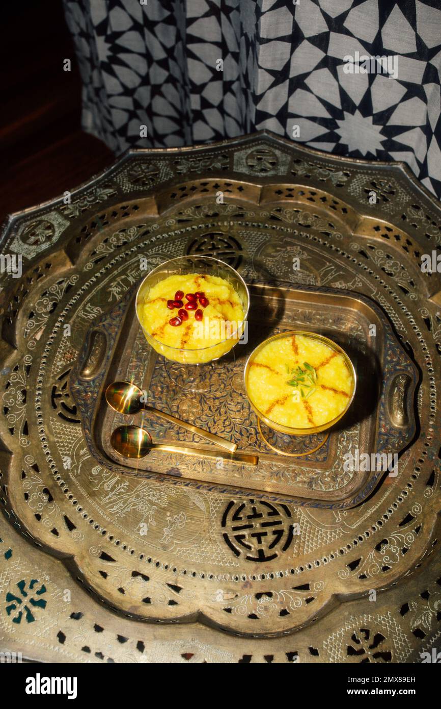 two servings of Sholeh Zard, a Persian saffron rice pudding, dessert ...