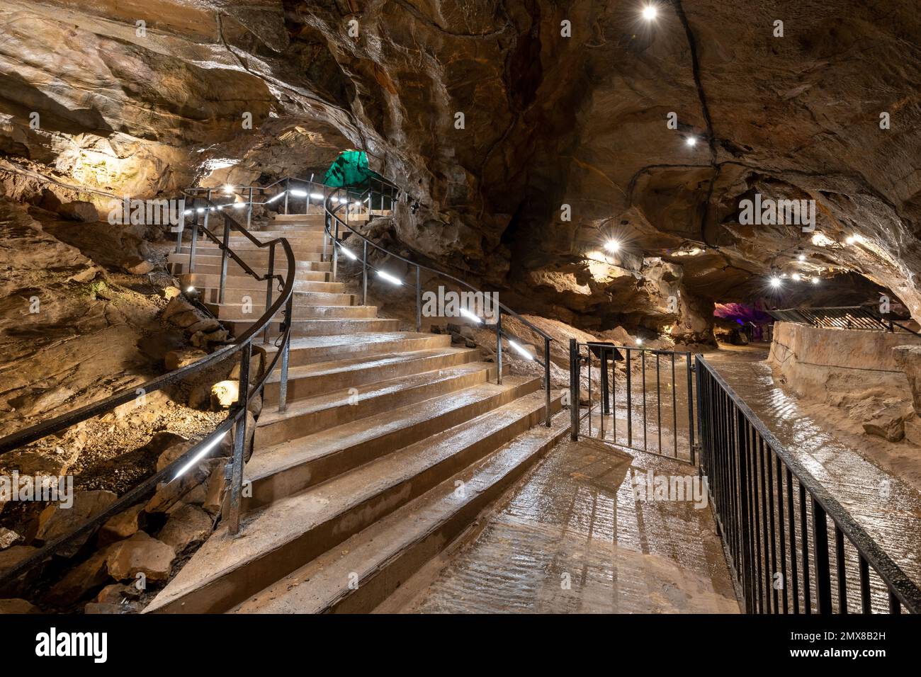 An illuminated staircase inside Goughs Cave in Cheddar in Somerset ...