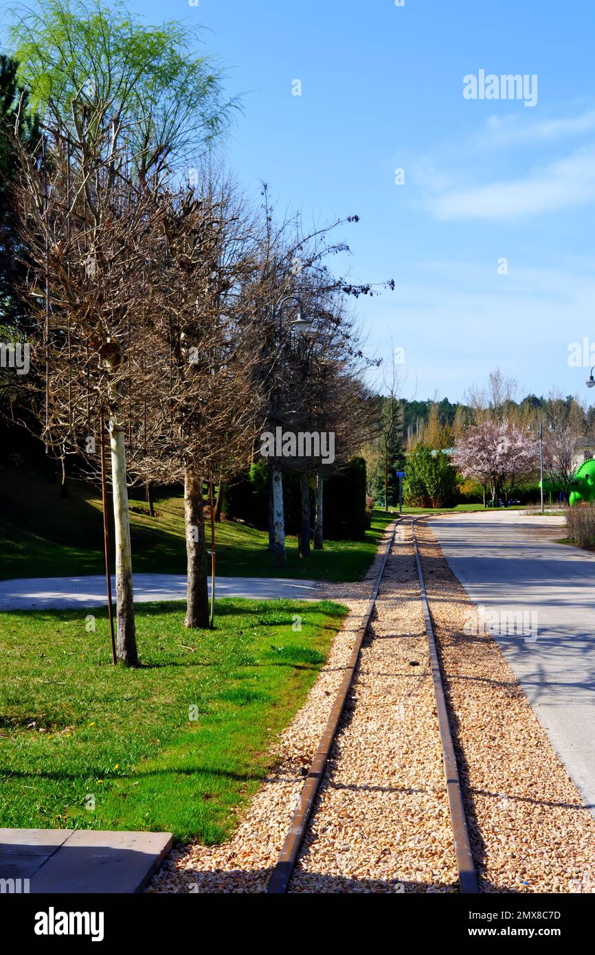 Railroad and pebbles at park within trees in a sunny spring day Stock ...
