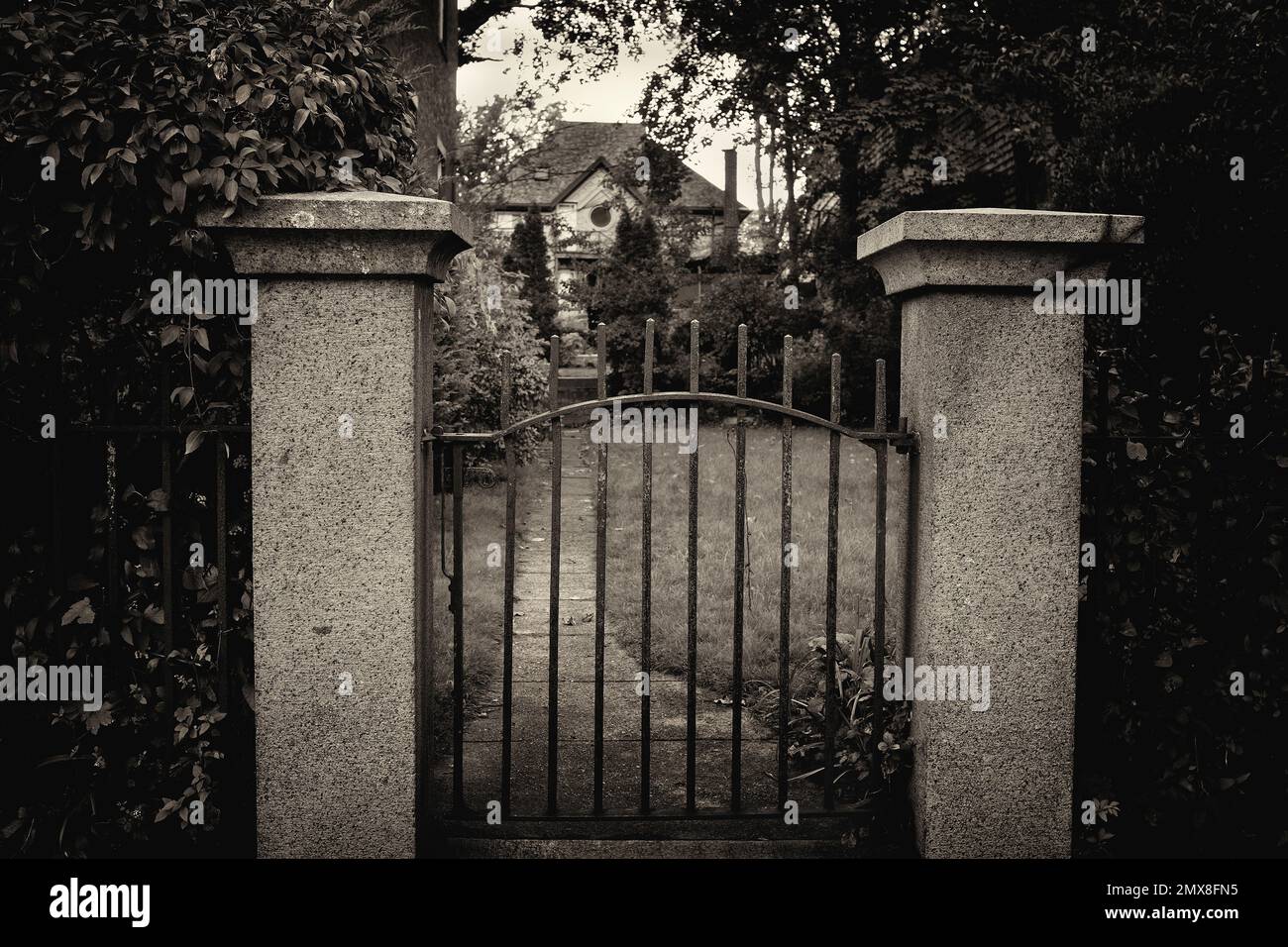 Wrought Iron Gate with Stone Columns, Large House in Background Stock ...