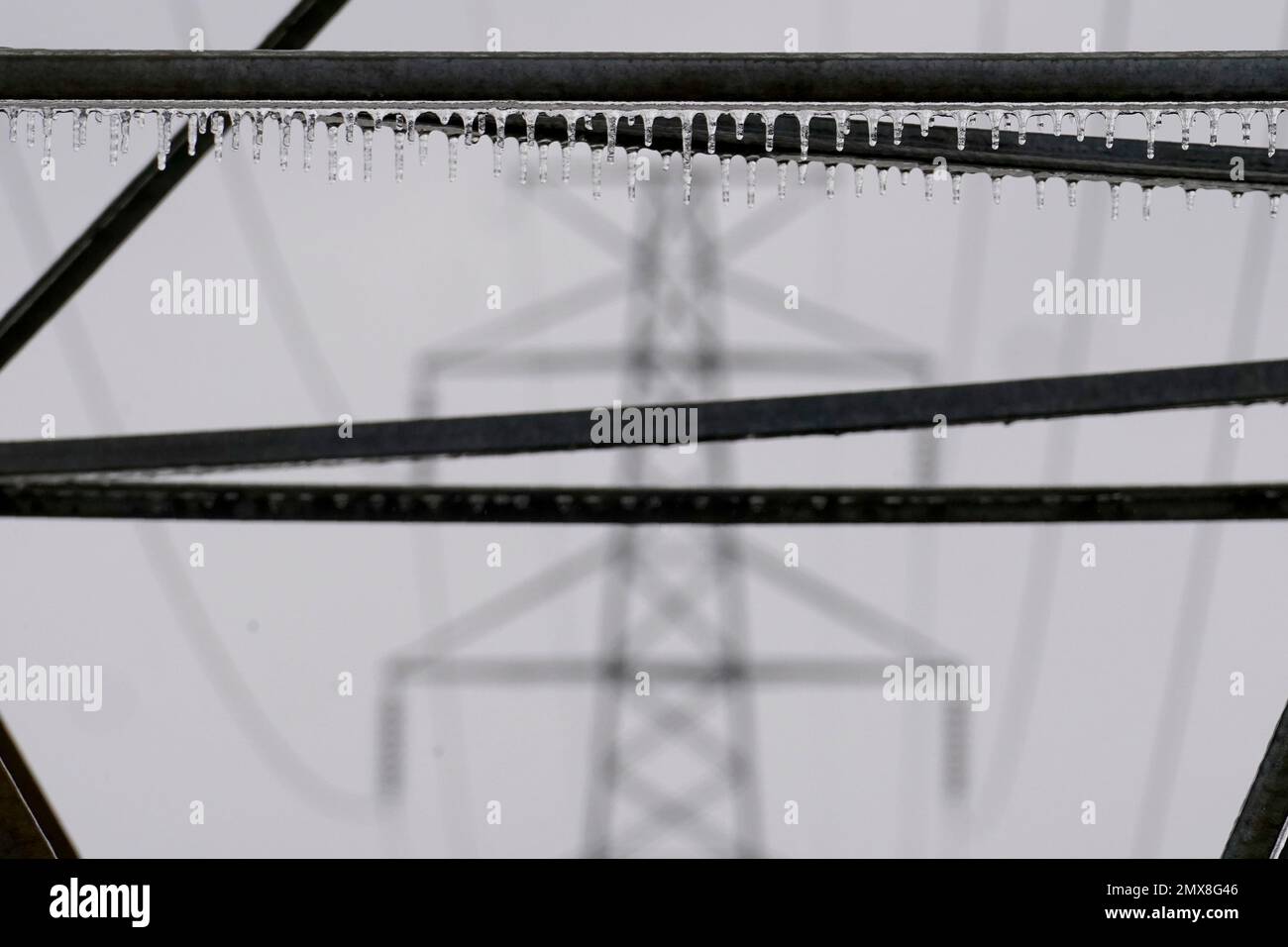 Icicles that formed on a power line structure from a few days of rain ...