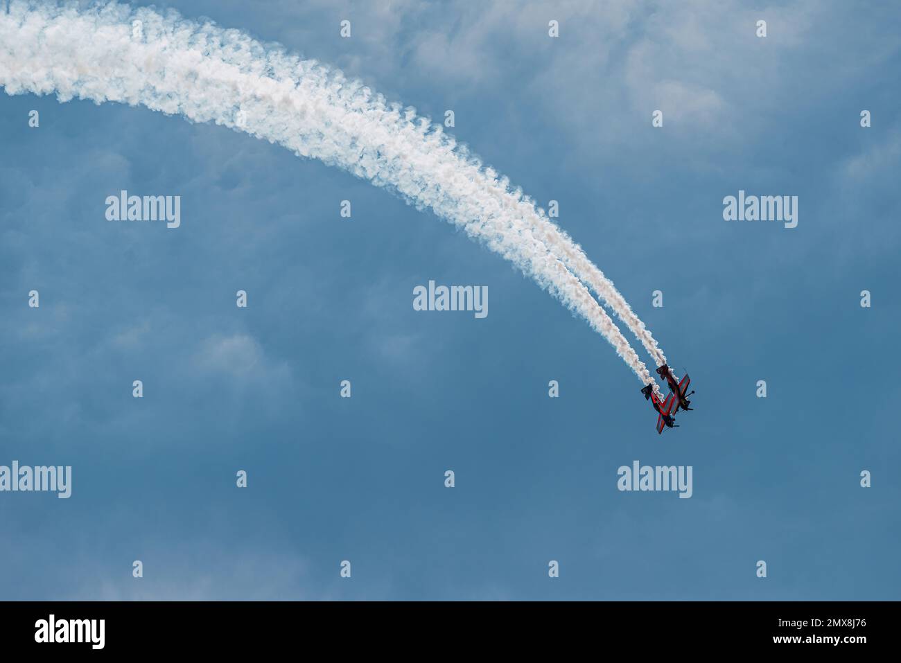 two small planes fly in parallel describing a white trajectory over the ...
