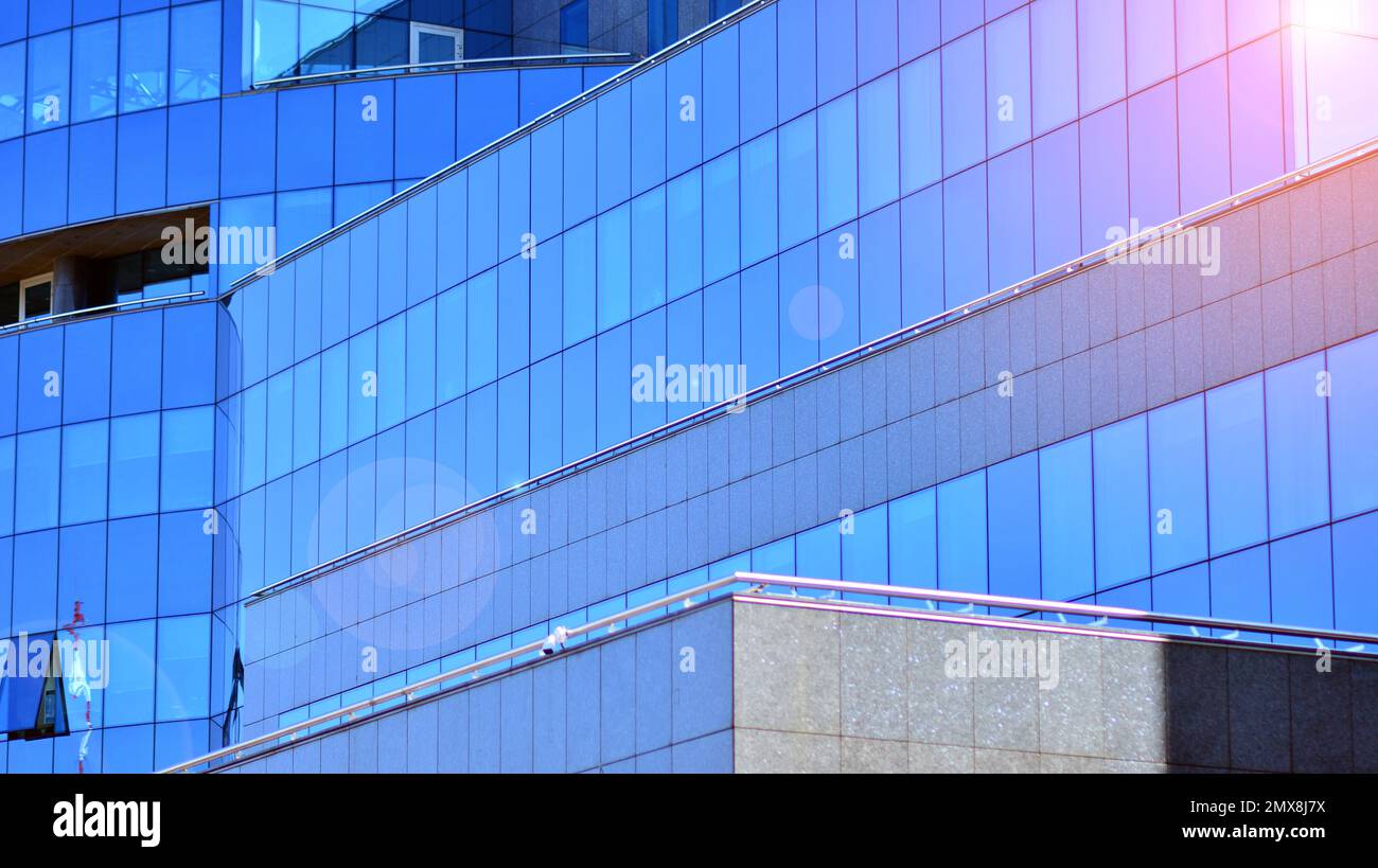Glass building with transparent facade of the building and blue sky ...