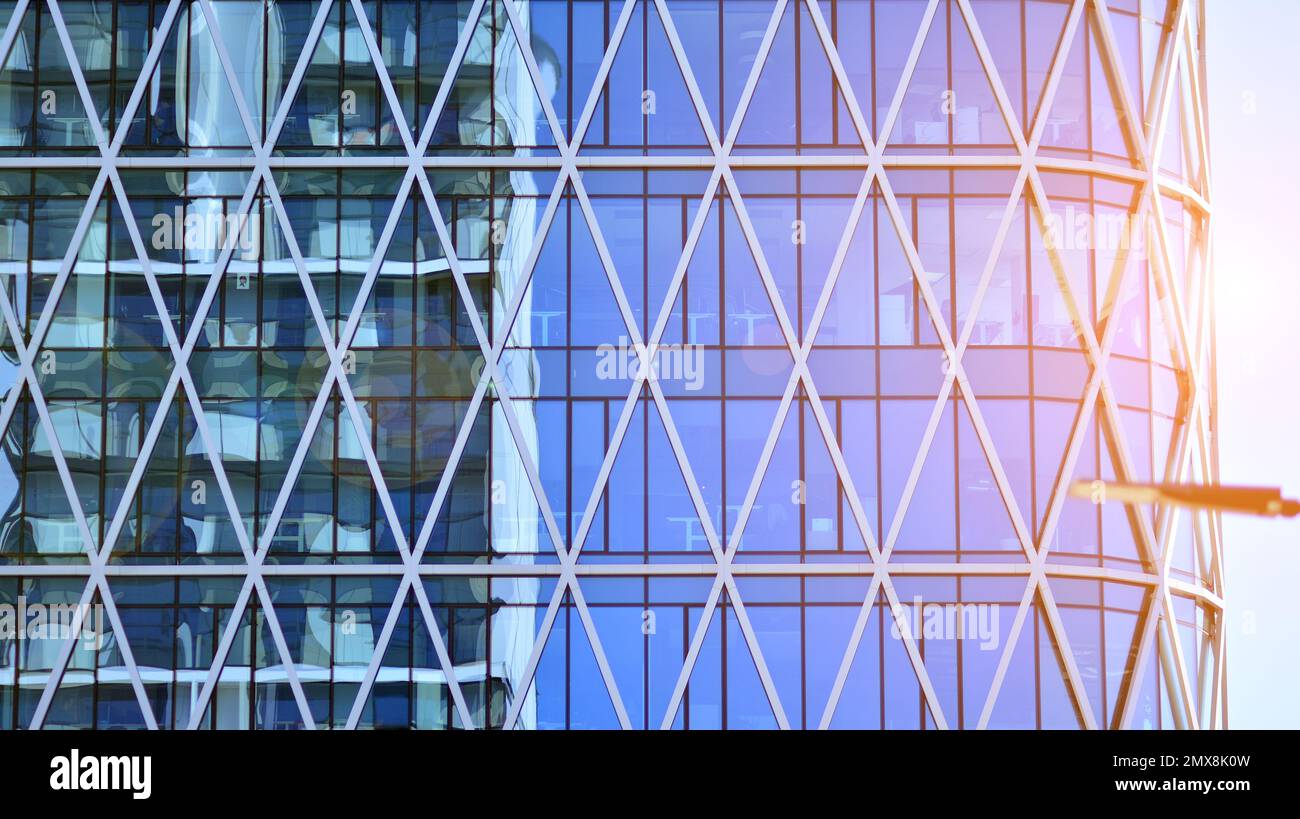 Glass building with transparent facade of the building and blue sky ...