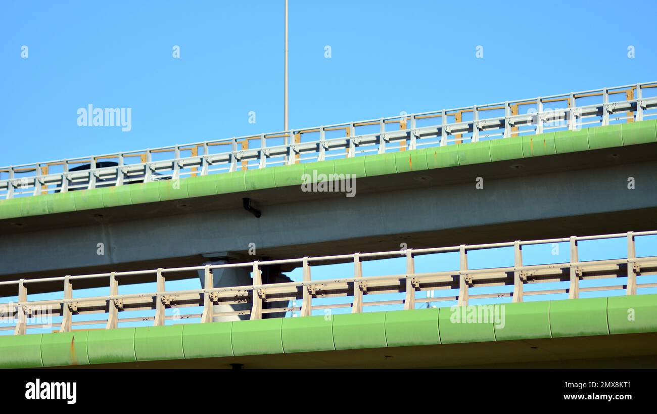Bridge against the blue sky. Motorway flyover. Elevated roads on sunny ...
