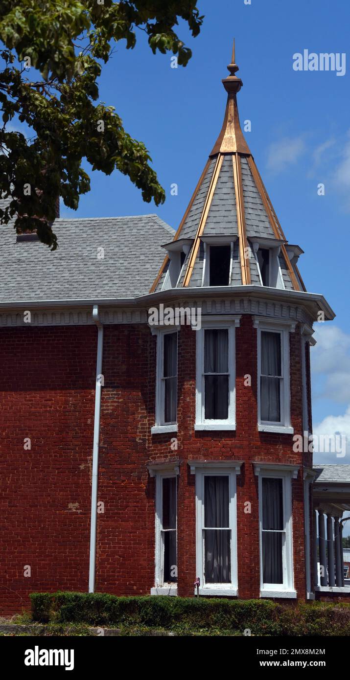 Turret on Victorian home is topped with copper trim and filial. Home is ...