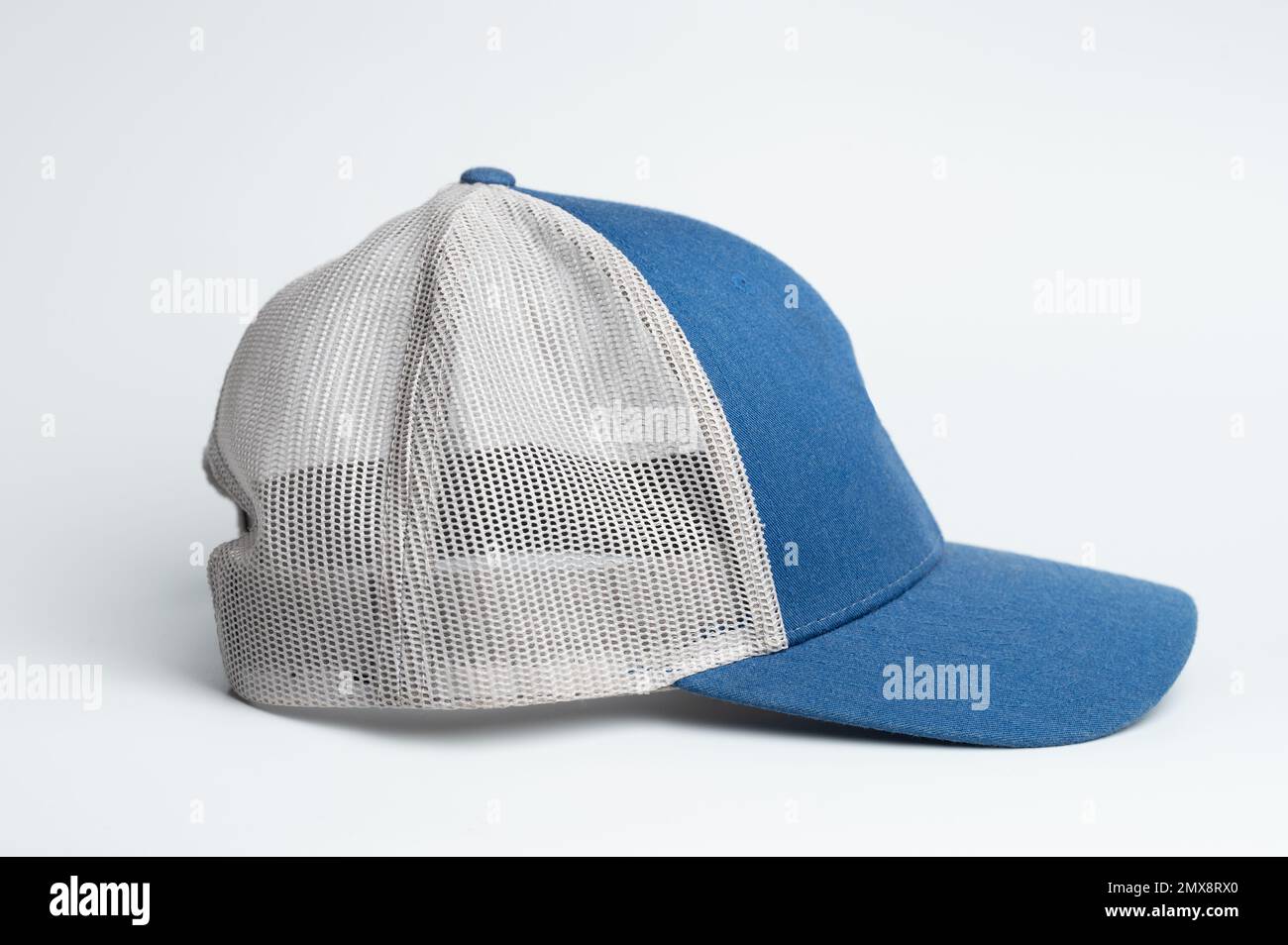 Blue jeans cap with perforation side view isolated on studio background ...