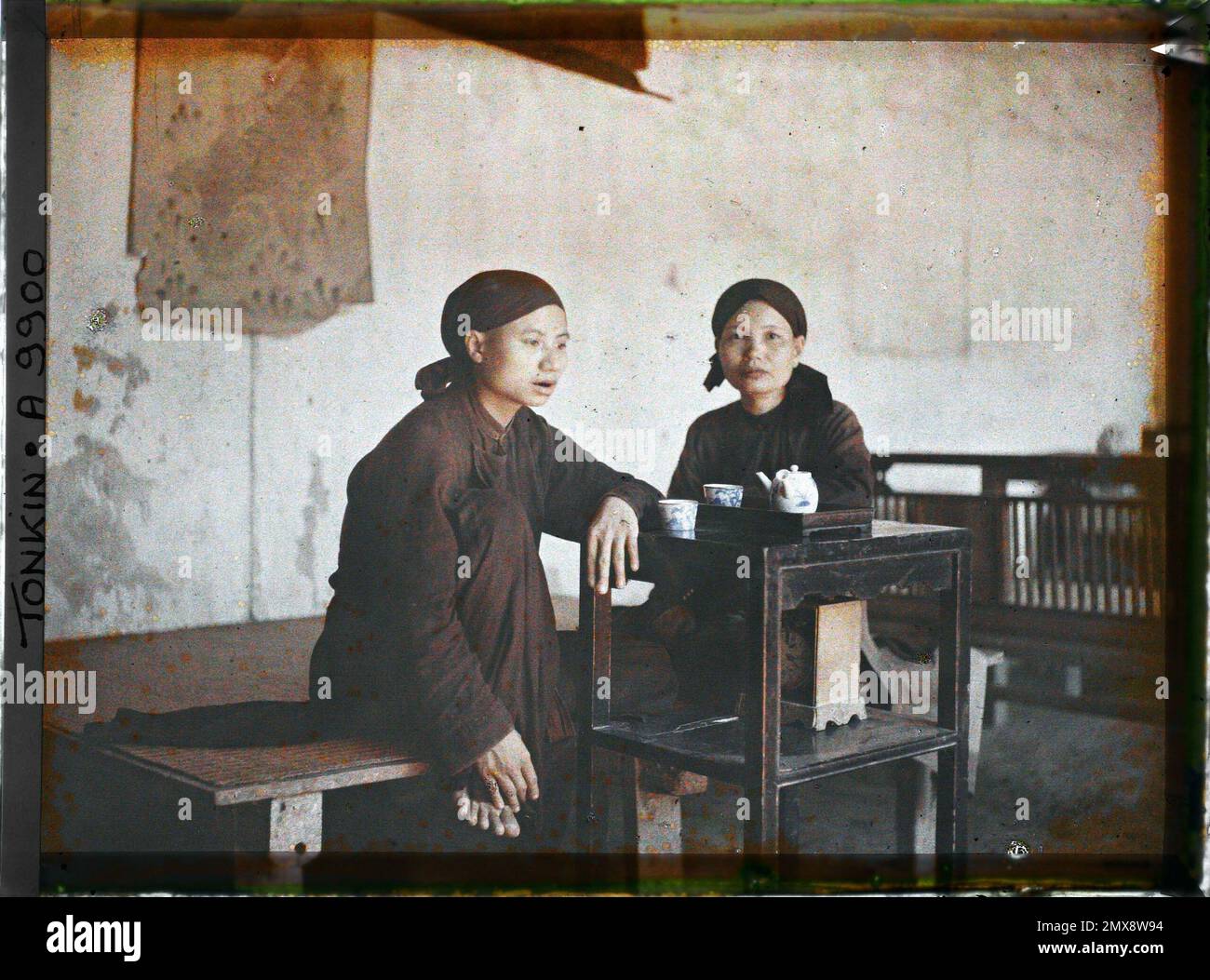 Hà-Nôi, Tonkin, Indochine Two novices sitting near a service supporting ...