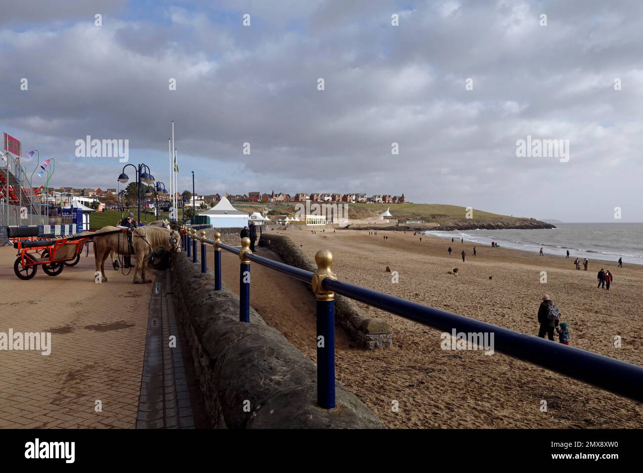 Ponies pulling training carts (Sulky, roadsters) tethered to the promenade railings at Barry ...