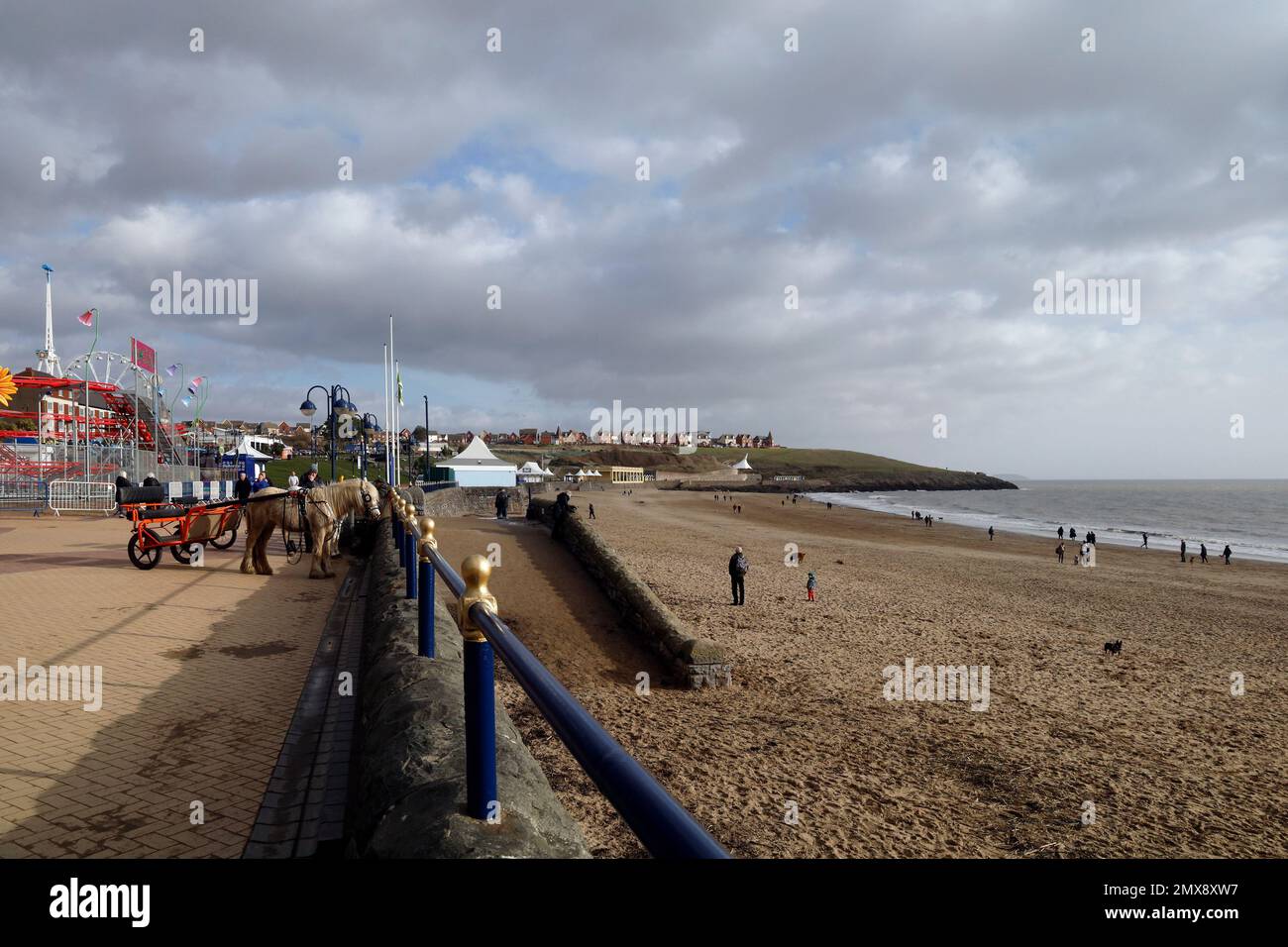 Ponies pulling training carts (Sulky, roadsters) tethered to the promenade railings at Barry ...