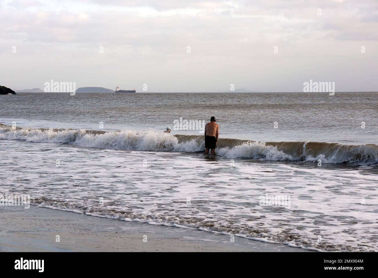 Brave mature couple winter swimming at Whitmore Bay, Barry Island. January 2023. Winter Stock ...