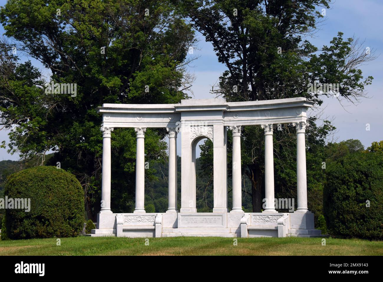 Beautiful, marble memorial with columns and benches stand in front of ...
