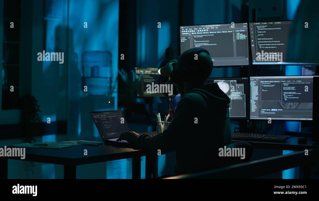 Software engineer yawning and feeling tired late at night, working on cloud computing with ...