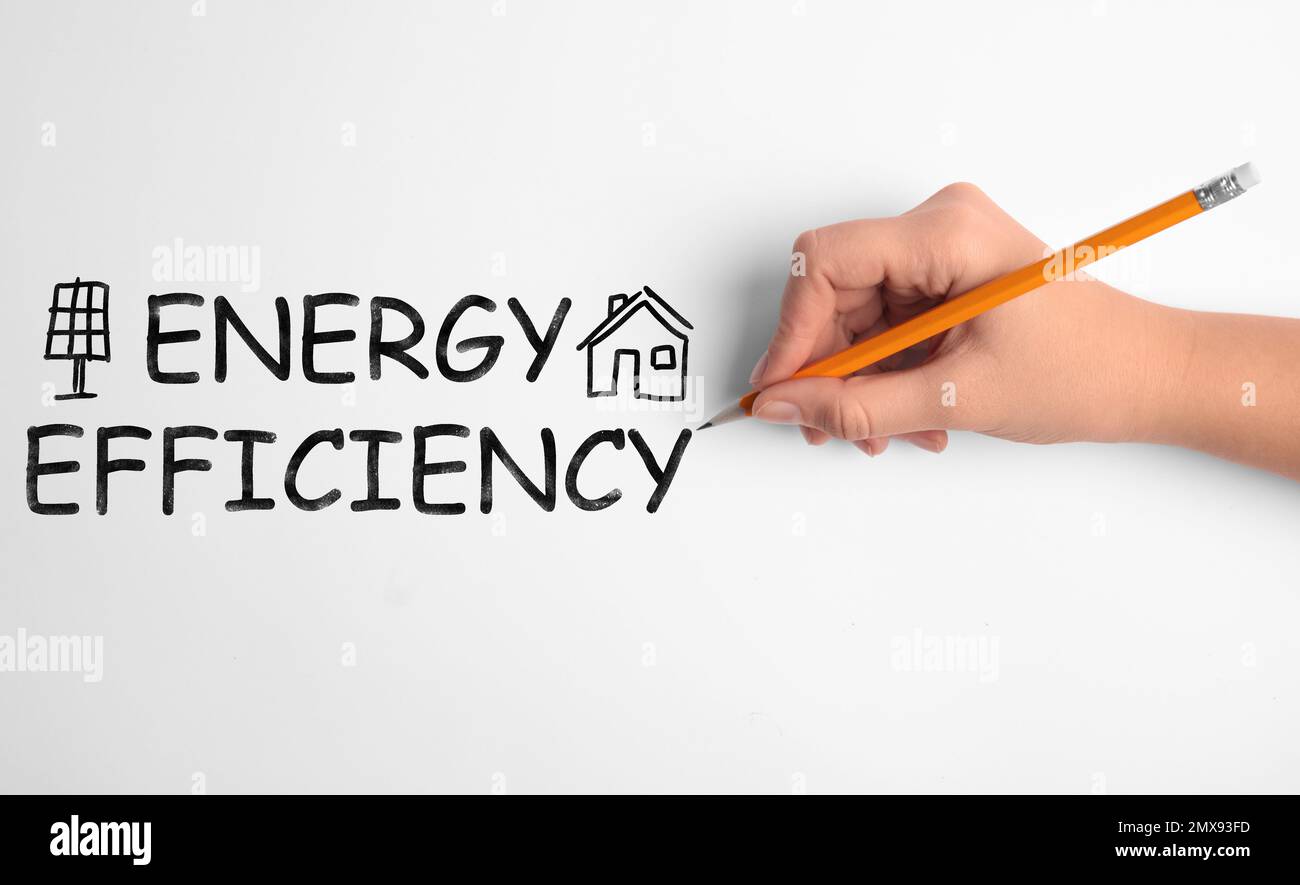 Energy efficiency concept. Woman writing on white background, closeup ...