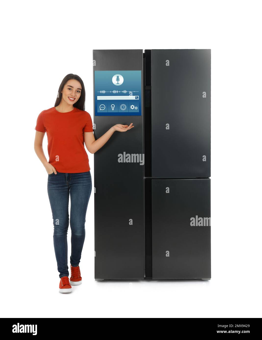 Young woman near smart refrigerator on white background Stock Photo - Alamy