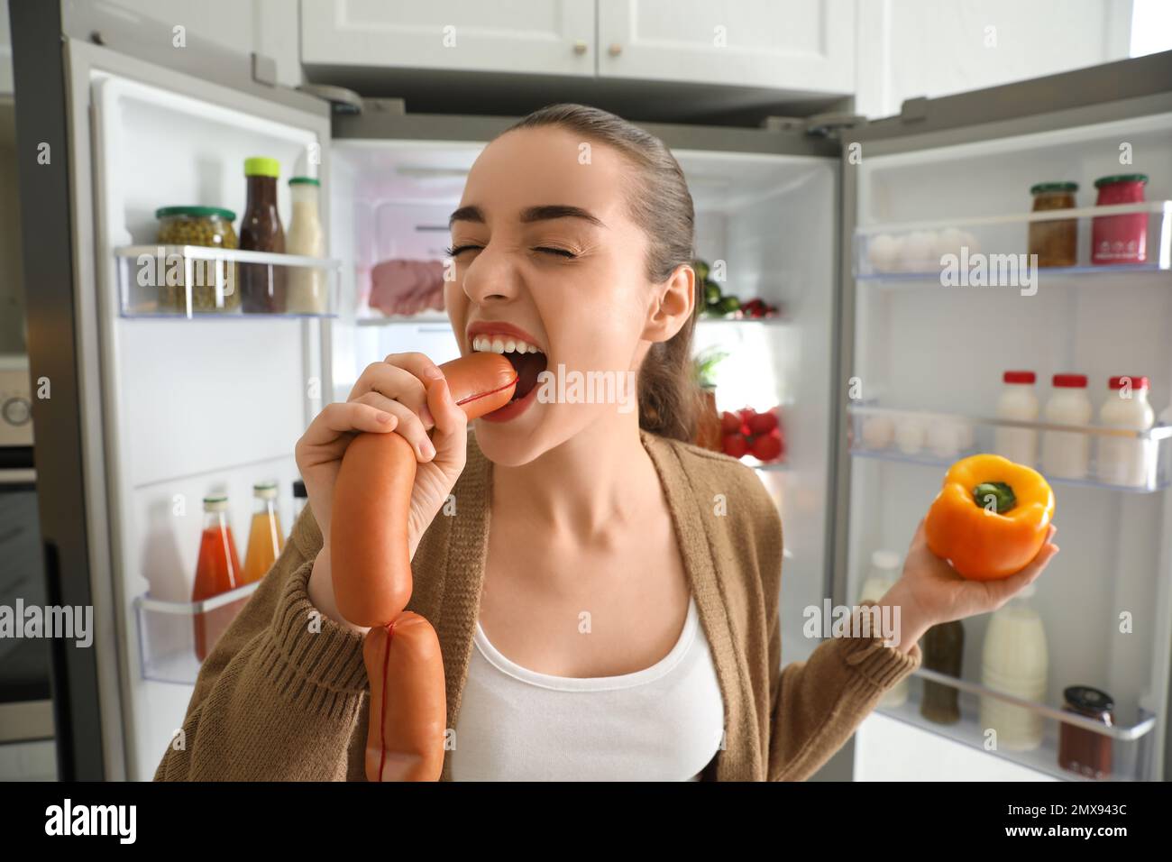 Woman eating sausage hi-res stock photography and images - Alamy