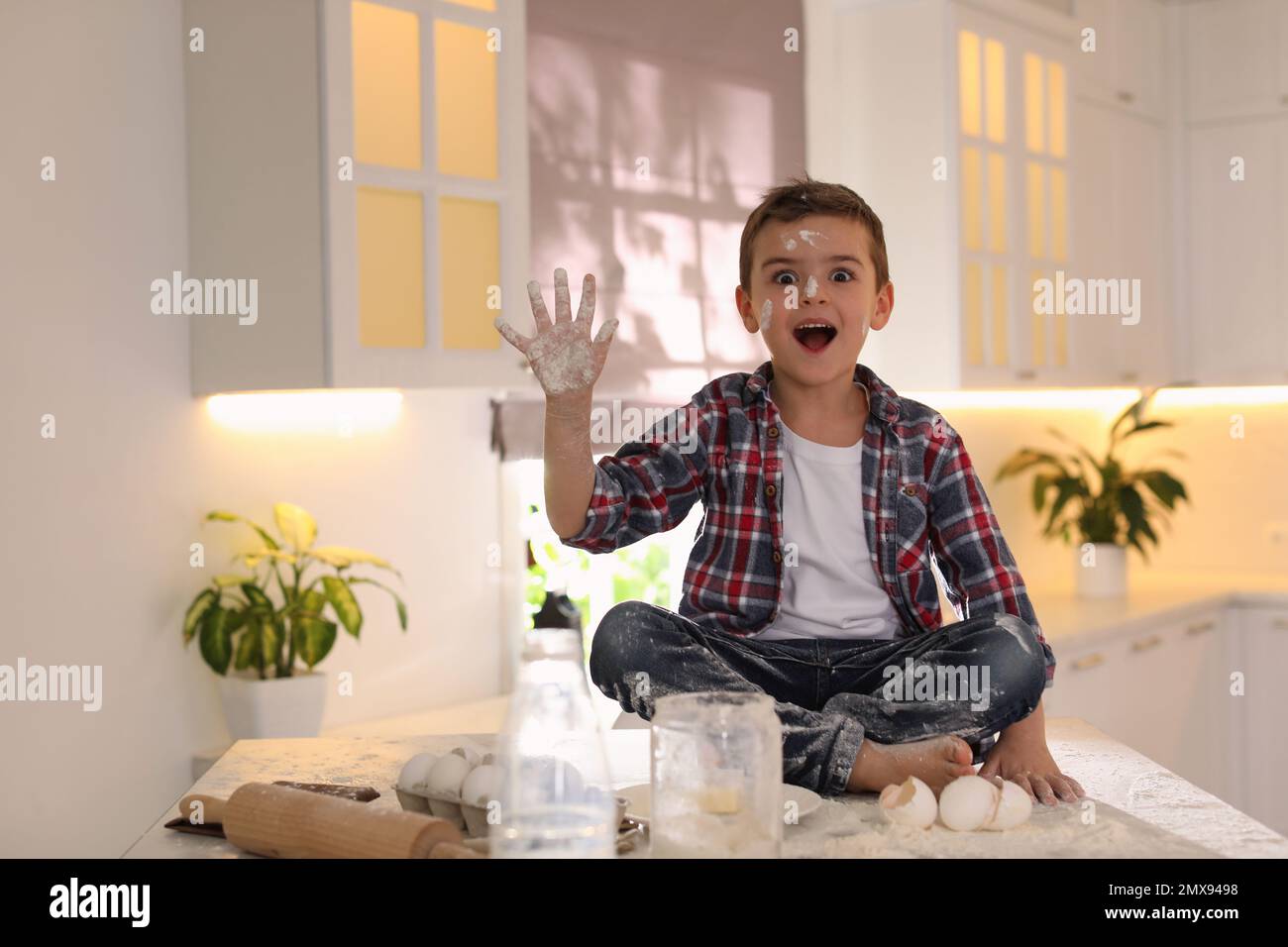 Emotional little boy with flour on face in kitchen. Cooking dough Stock ...