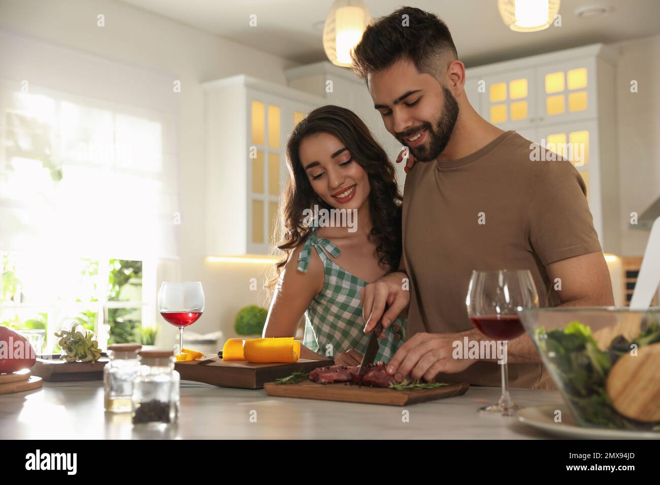 Couple kitchen meat hi-res stock photography and images - Alamy