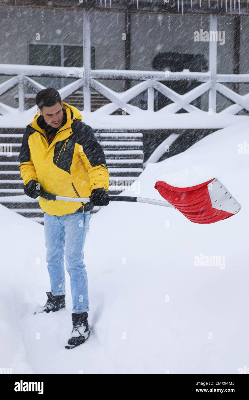 Man shoveling snow near hi-res stock photography and images - Alamy
