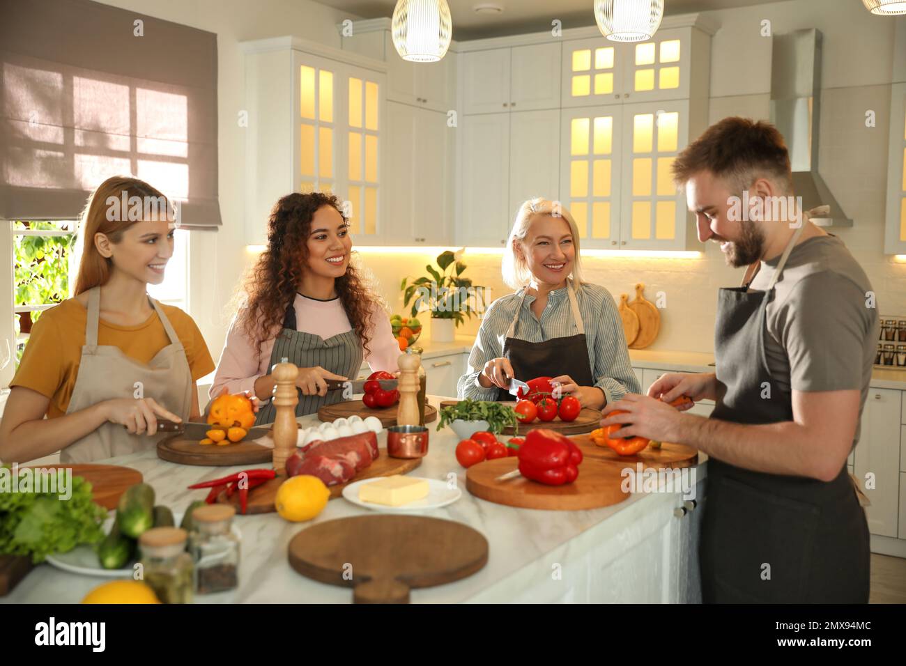 Happy people cooking food together in kitchen Stock Photo - Alamy
