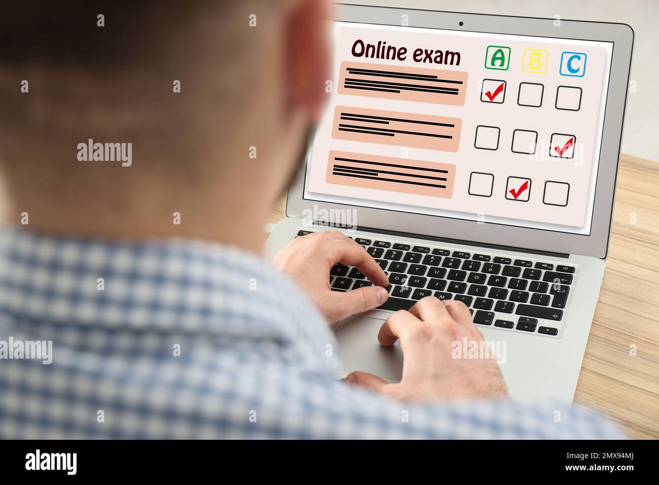 Student passing online exam at wooden table, closeup Stock Photo - Alamy