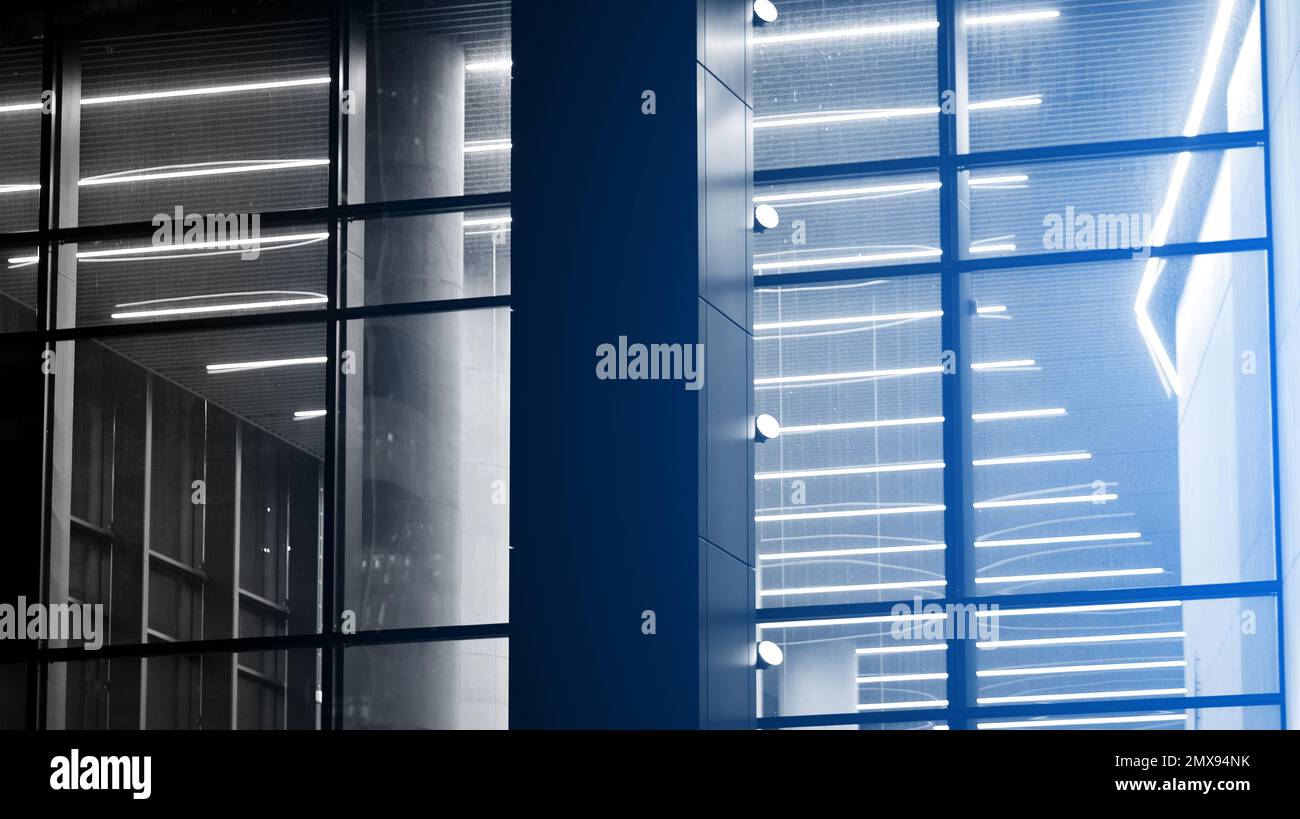 Pattern of office buildings windows illuminated at night. Lighting with ...