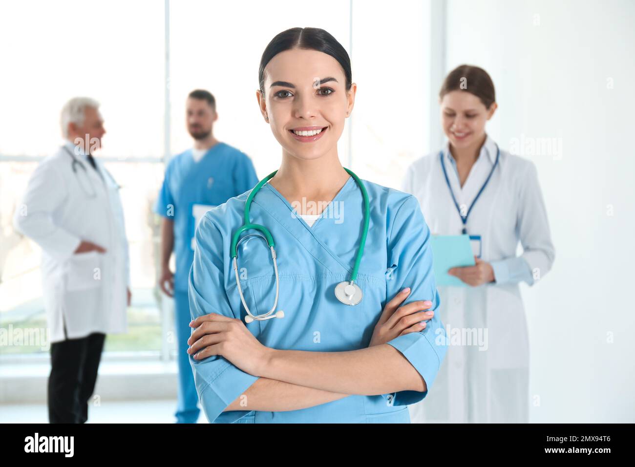 Young doctor and colleagues in hospital. Medical service Stock Photo ...