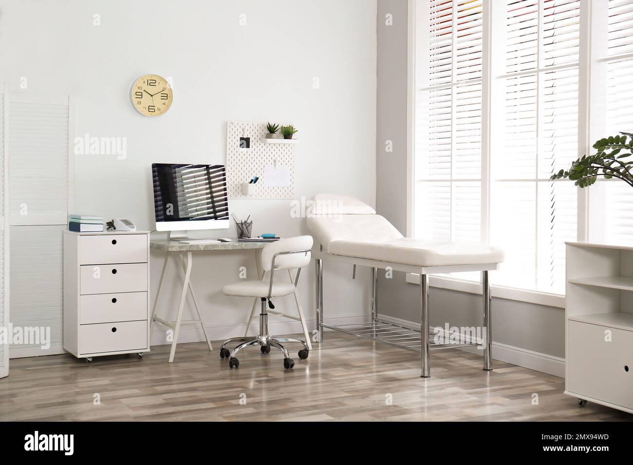 Modern medical office interior with computer and examination table ...