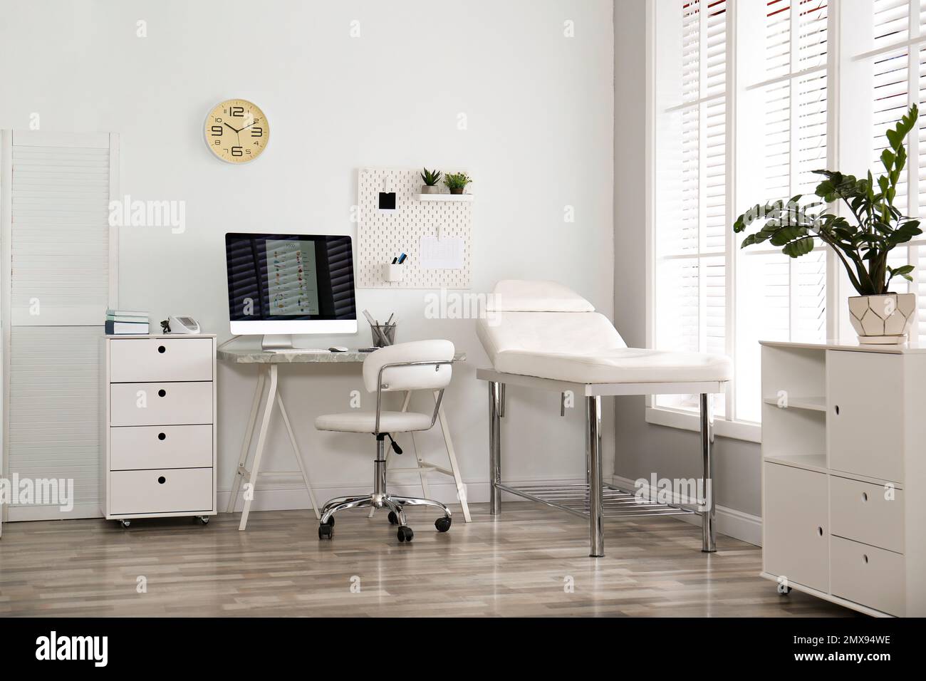Modern medical office interior with computer and examination table ...