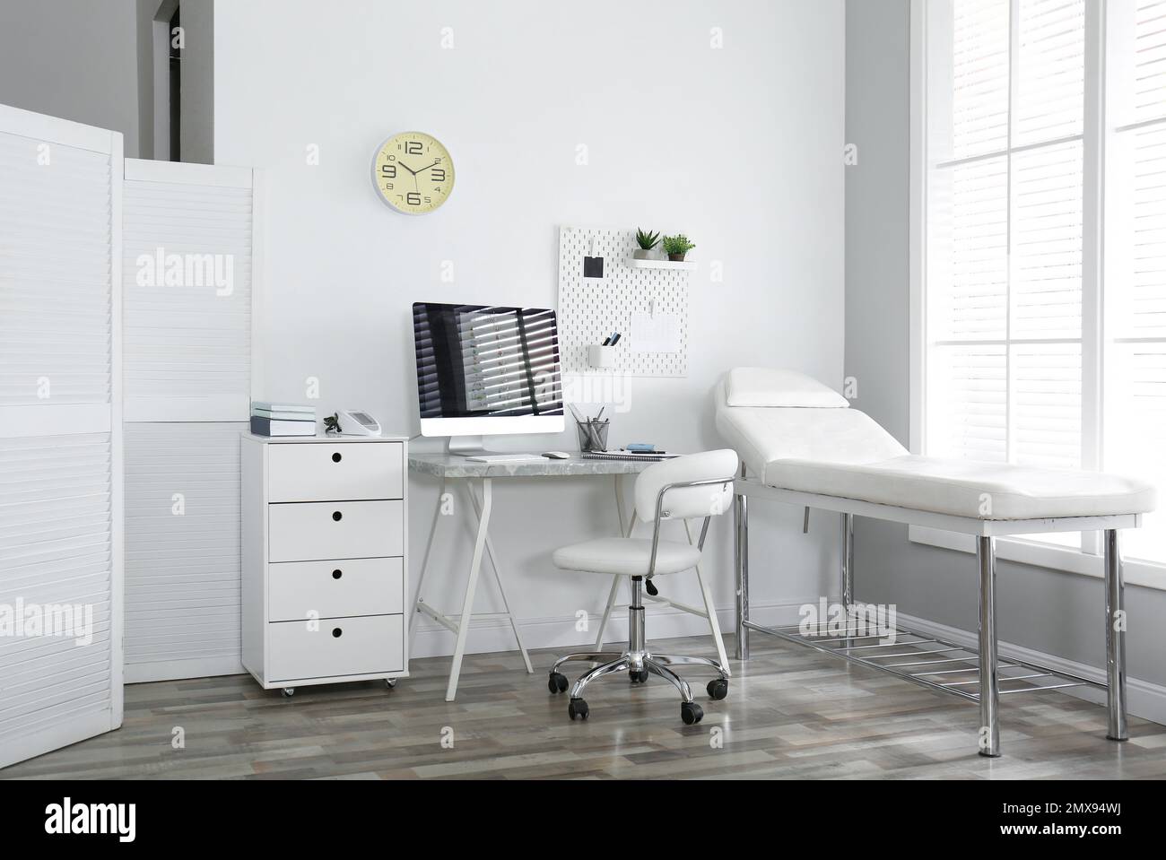 Modern medical office interior with computer and examination table ...