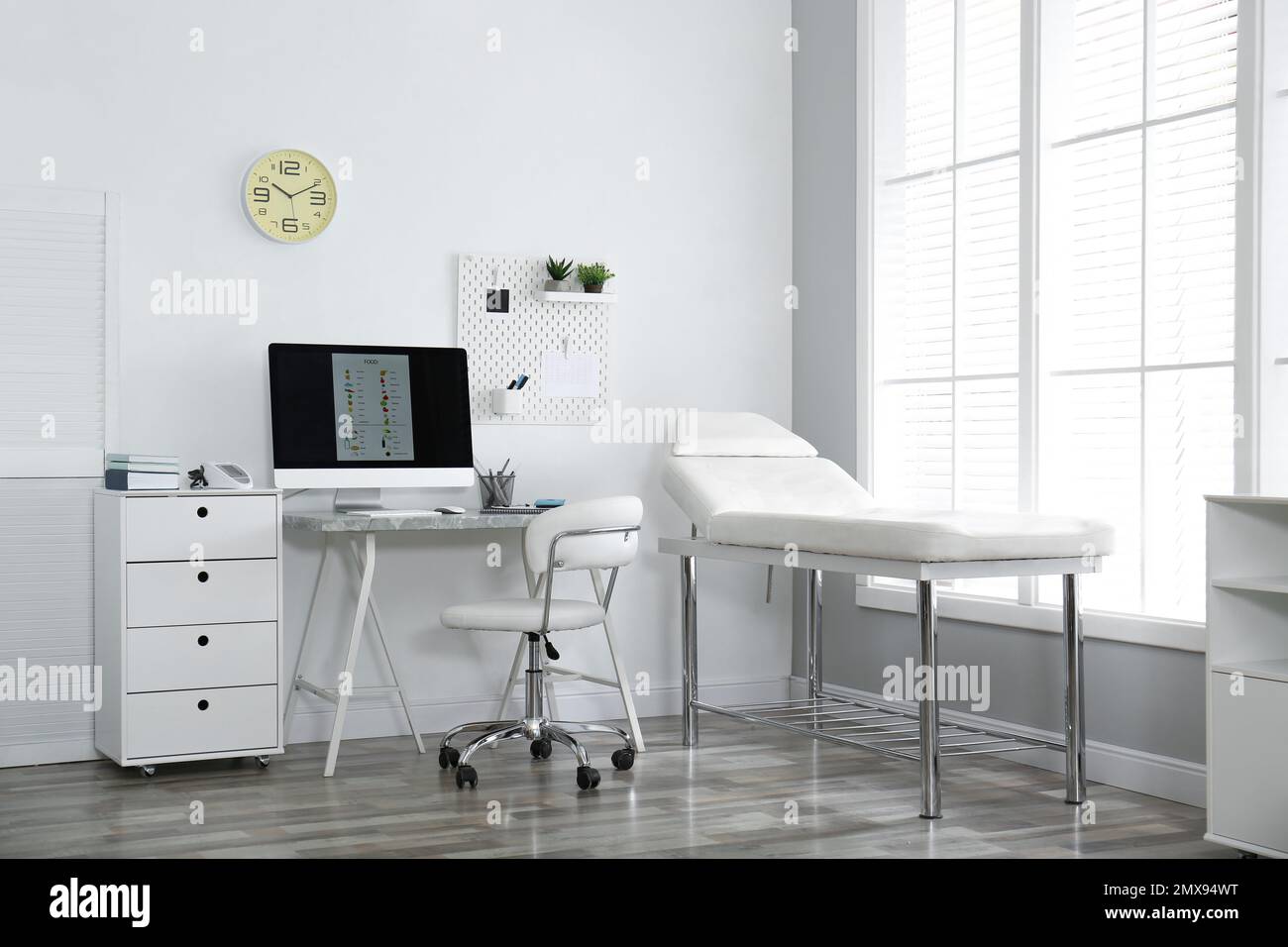 Modern medical office interior with computer and examination table ...