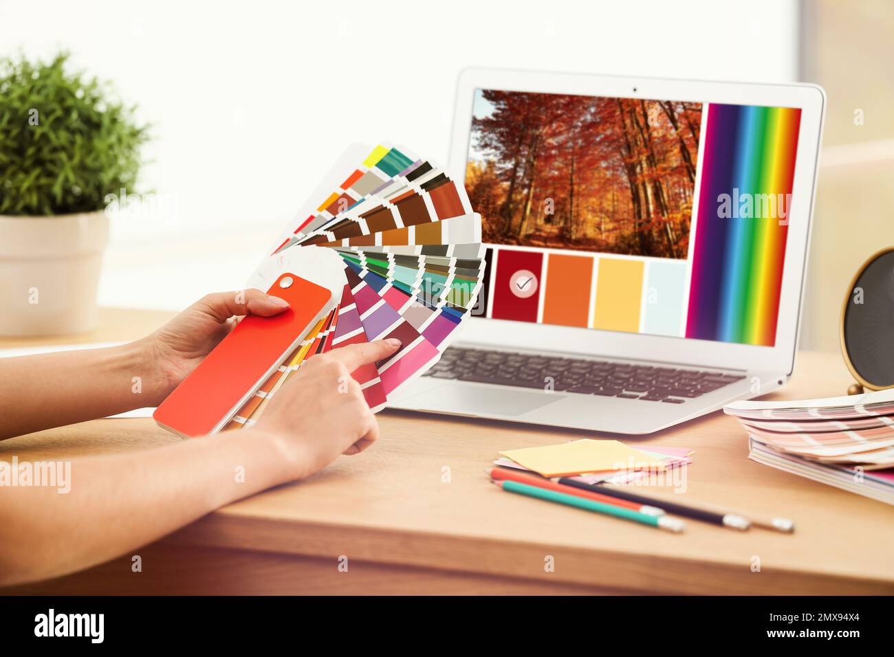Professional female designer working with color palette samples and ...