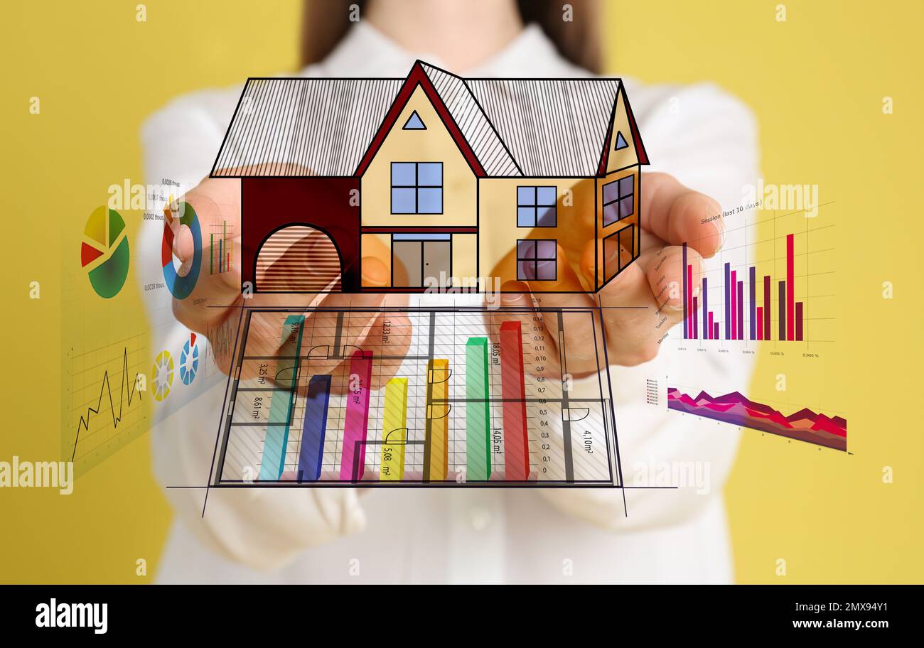 Designer presenting project of house with charts on yellow background ...