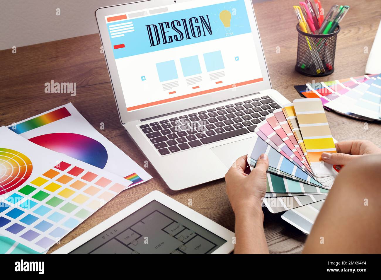 Professional female designer working with color palette samples and ...